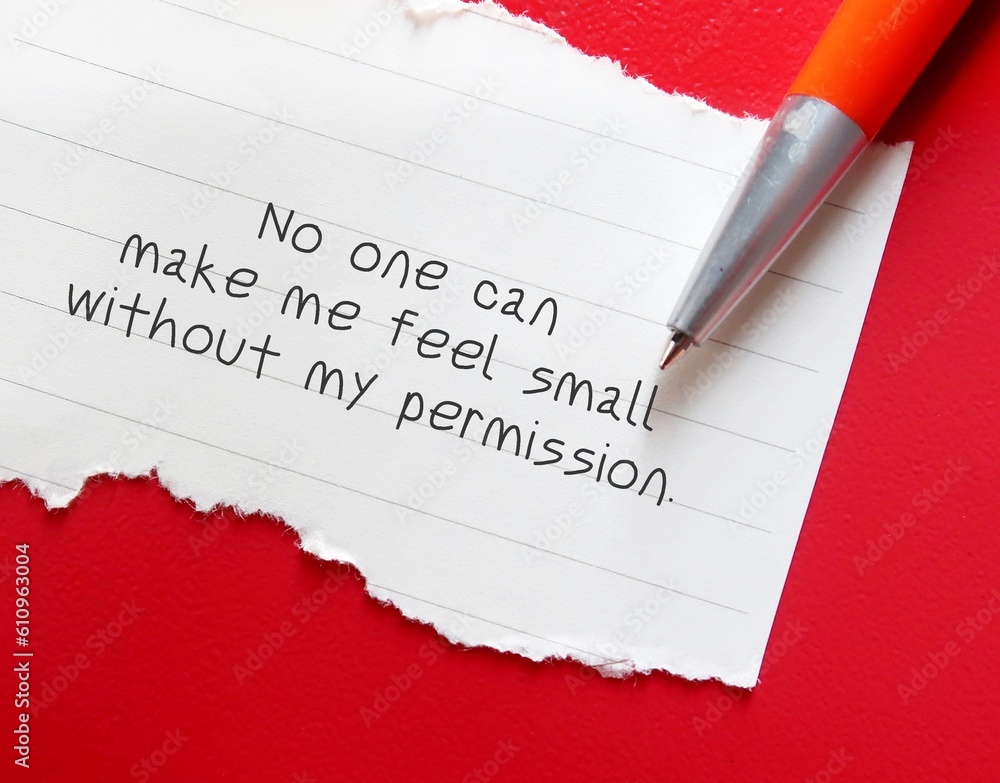 Torn note on red background with handwriting text - No one can make me ...