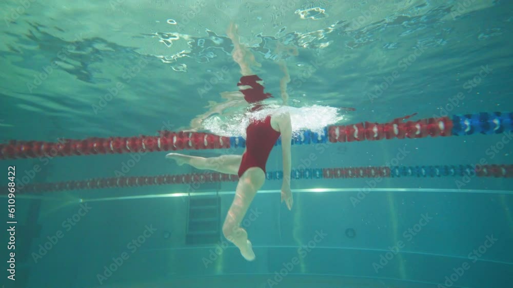 Professional female swimmer in the pool, young woman perform the ...