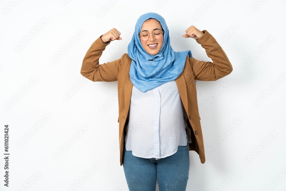 Strong powerful Young beautiful pregnant muslim woman wearing hijab ...
