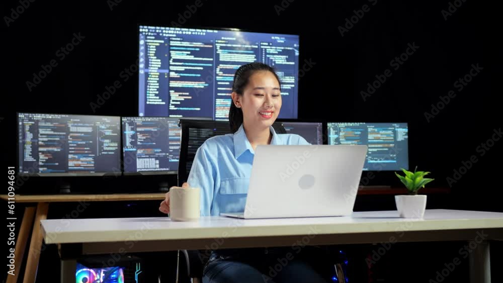 Asian Female Programmer Drinking Coffee While Writing Code By A Laptop ... Asian Female Programmer Drinking Coffee While Writing Code By A Laptop ...
