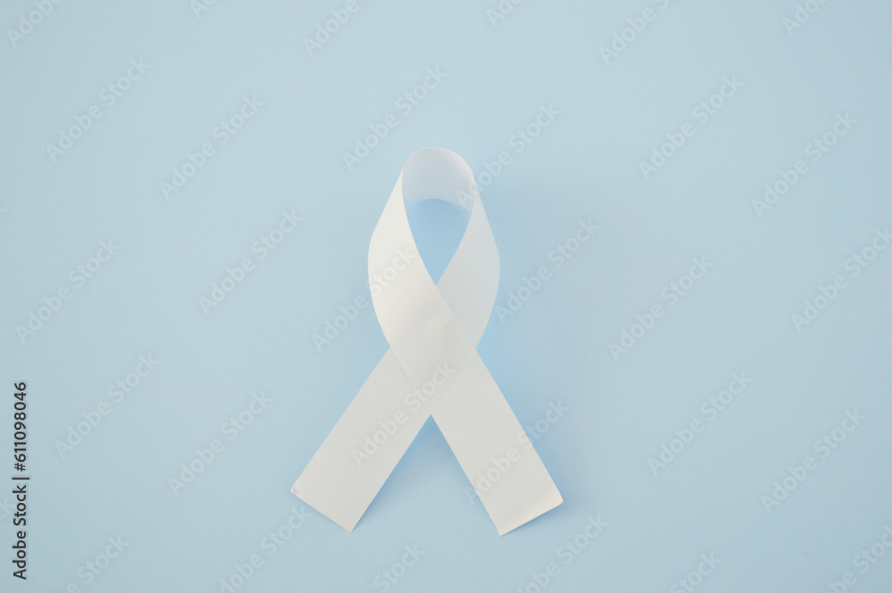 White ribbon as a symbol of peace on a blue background. World Day of ...