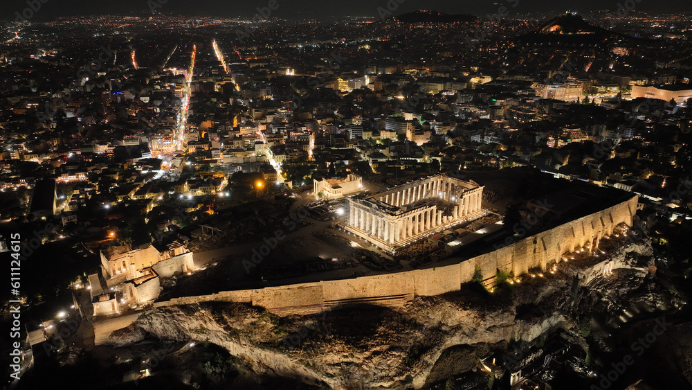 Aerial drone night shot of iconic illuminated Acropolis hill and the Parthenon an Unesco world ...