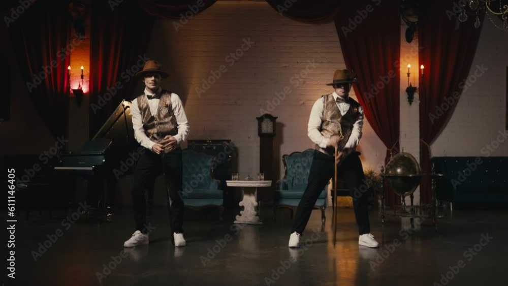 Two stylish professional male dancers in classy dandy hat performing ...