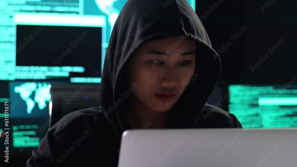 Close Up Of Asian Female Hacker In A Hood Showing Hand Palm To Camera While Works On A Laptop ...