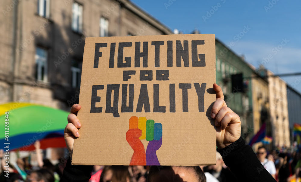 Woman holding placard sign Fighting for Equality with rainbow flag fist ...