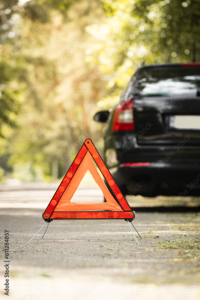 Red triangle, red emergency stop sign and black car with technical ...