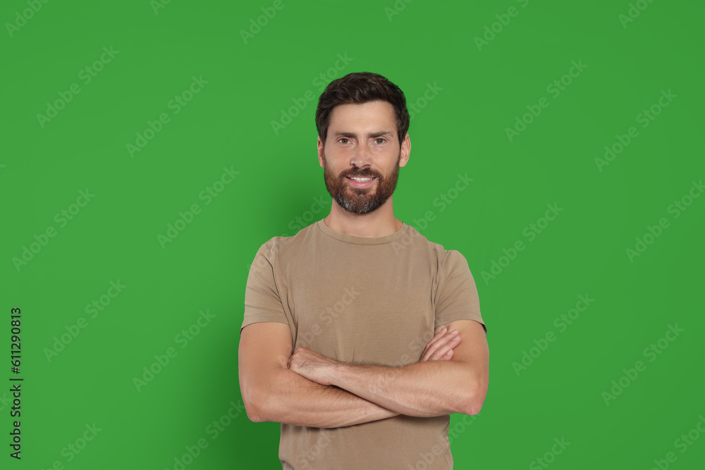 Chroma key compositing. Handsome man smiling against green screen Stock ...