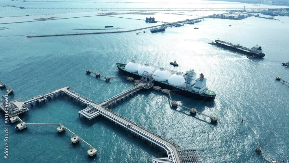 LNG (Liquified Natural Gas) tanker anchored in Gas terminal gas tanks ...