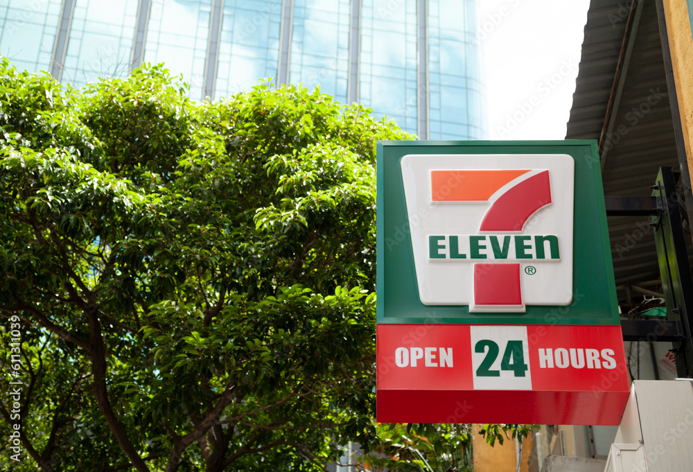 Ho Chi Minh City, Vietnam - June 4, 2023: Green and red information sign with 7-eleven logo on a ...