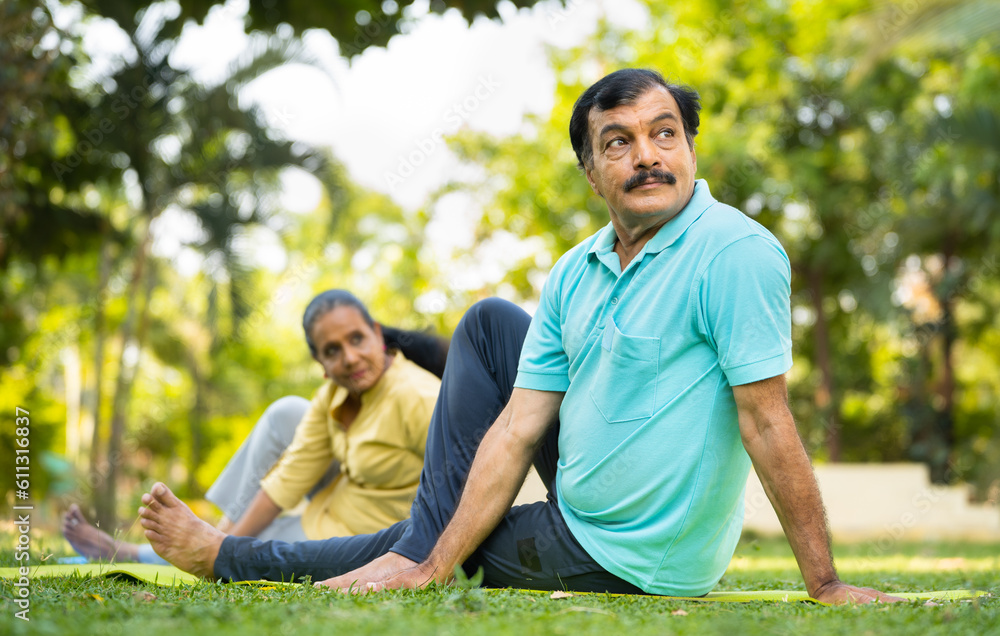 Indian elderly senior people at park doing stretching exercise or yoga ...