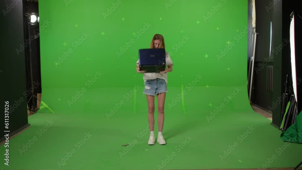Angry worker breaking laptop. Young woman throwing the computer on ...