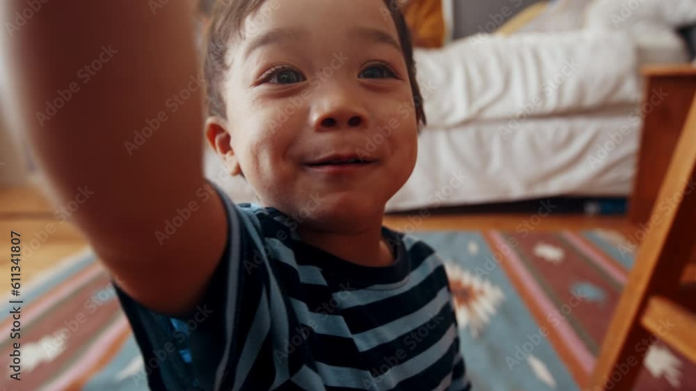 Curious little boy laughing and chatting with someone in an authentic ...