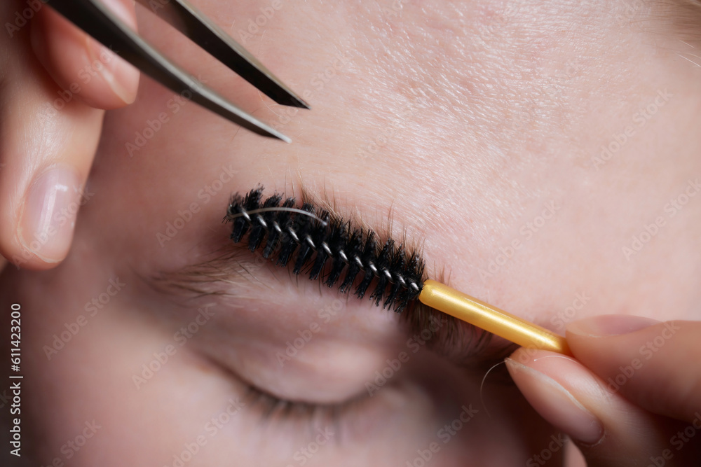 Professional barber doing threading procedure and correcting shape of ...