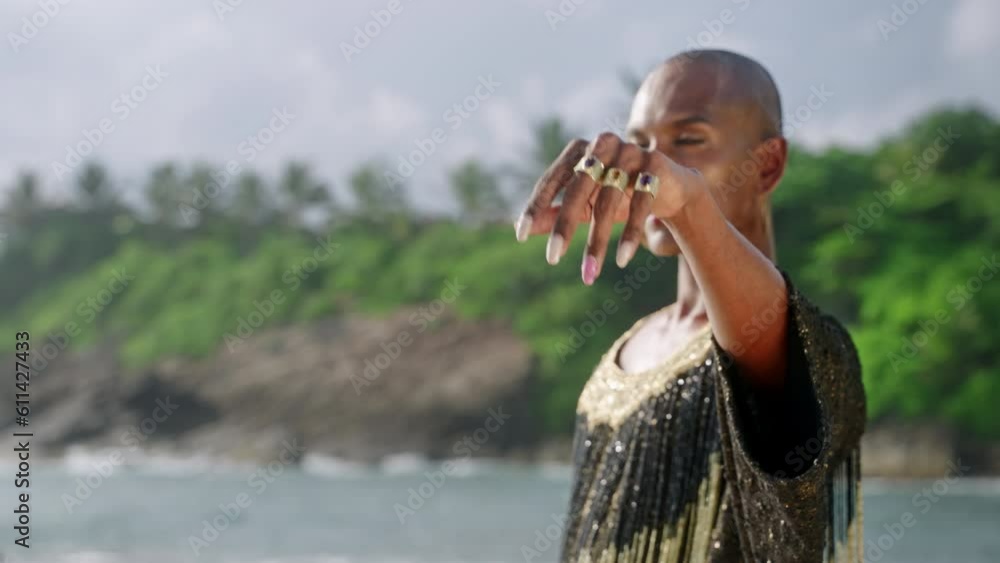 Gender fluid person of color in luxury dress, jewelry poses on stormy ...
