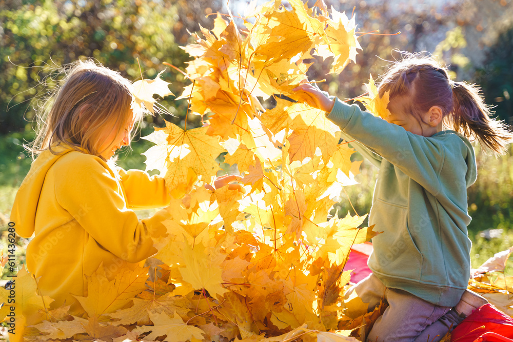 Girls kids playing jumping on trampoline with autumn leaves. Bright ...