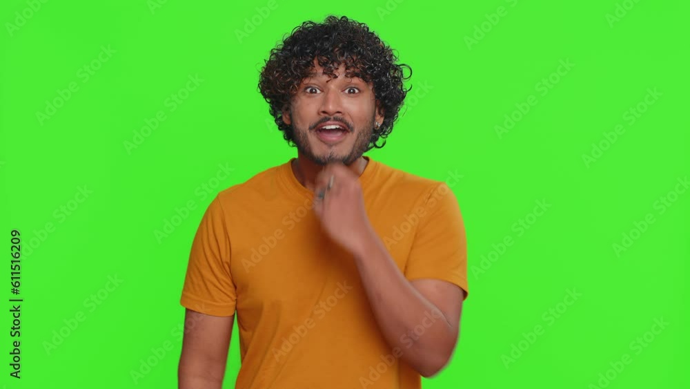 Eureka. Inspired young indian man pointing finger up with open mouth ...