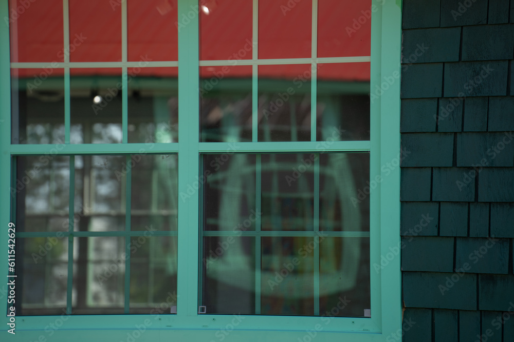 reflection in window of other windows with distortion from glass square ...