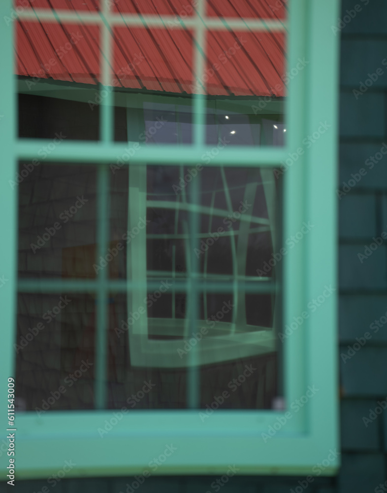 reflection in window of other windows with distortion from glass square ...