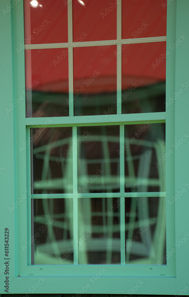 reflection in window of other windows with distortion from glass square ...