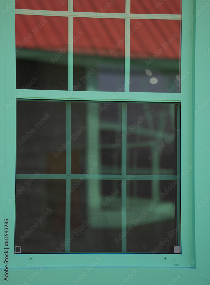 reflection in window of other windows with distortion from glass square ...