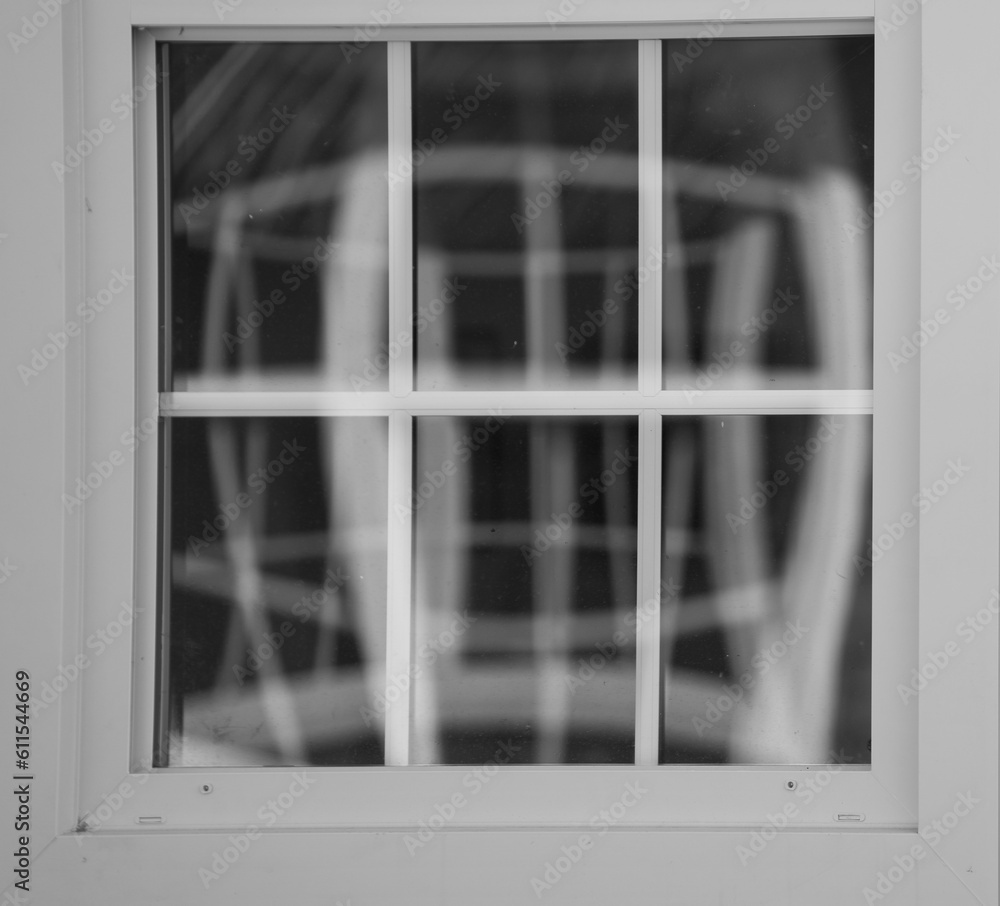black and white of wooden window frame glass reflecting other windows ...