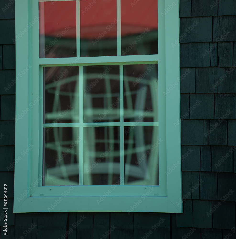 reflection in window of other windows with distortion from glass square ...