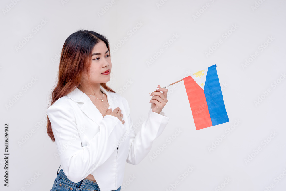 A nationalistic young woman holding one hand to her chest and facing to ...