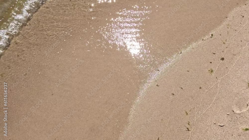 Sea water flooding the sand on the beach. Background with a beach ...