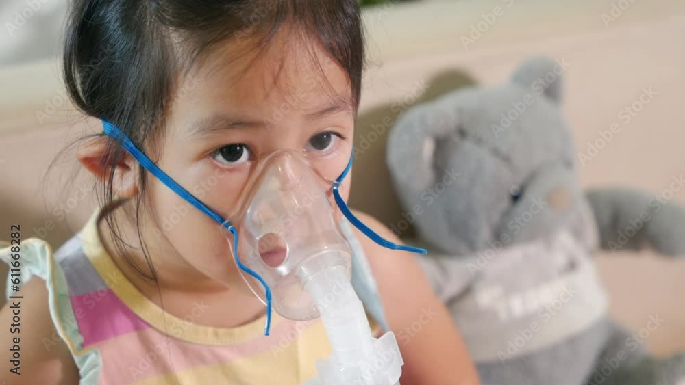 Kid girl making makes inhalation nebulizer steam sick cough at home ...