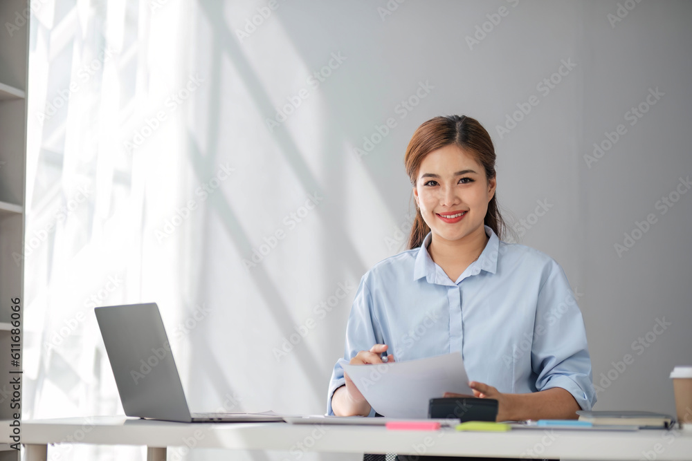 Charming Young asian businesswoman sitting on laptop computer in the ...