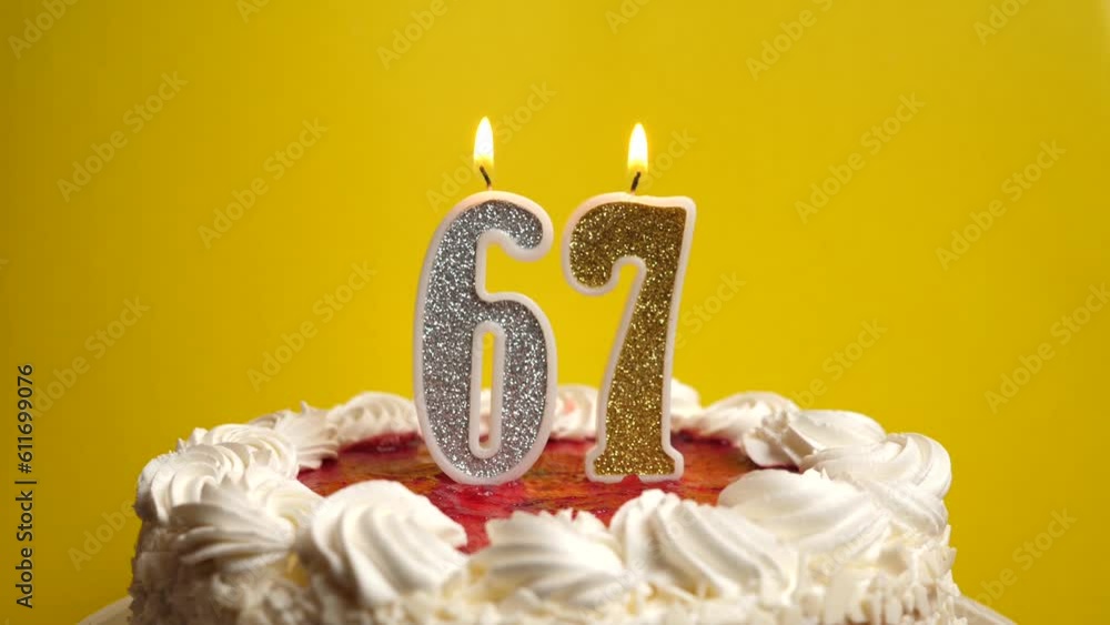 A candle in the form of the number 67, inserted into the holiday cake ...
