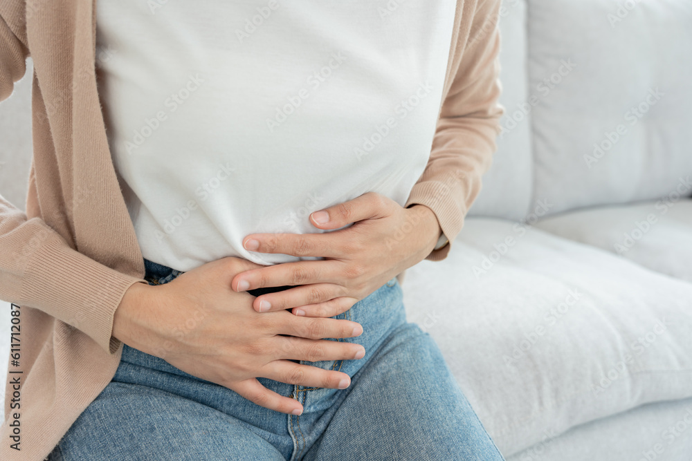 Foto de Constipation and diarrhea in bathroom. Hurt woman touch belly ...