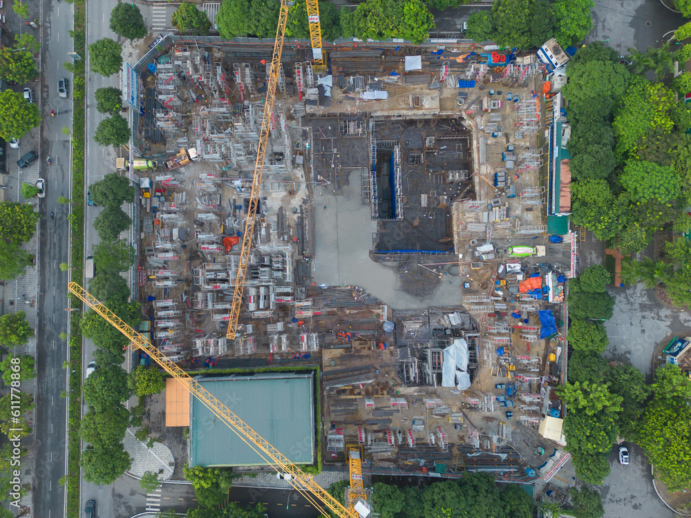 Aerial view of busy industrial under construction site workers working ...