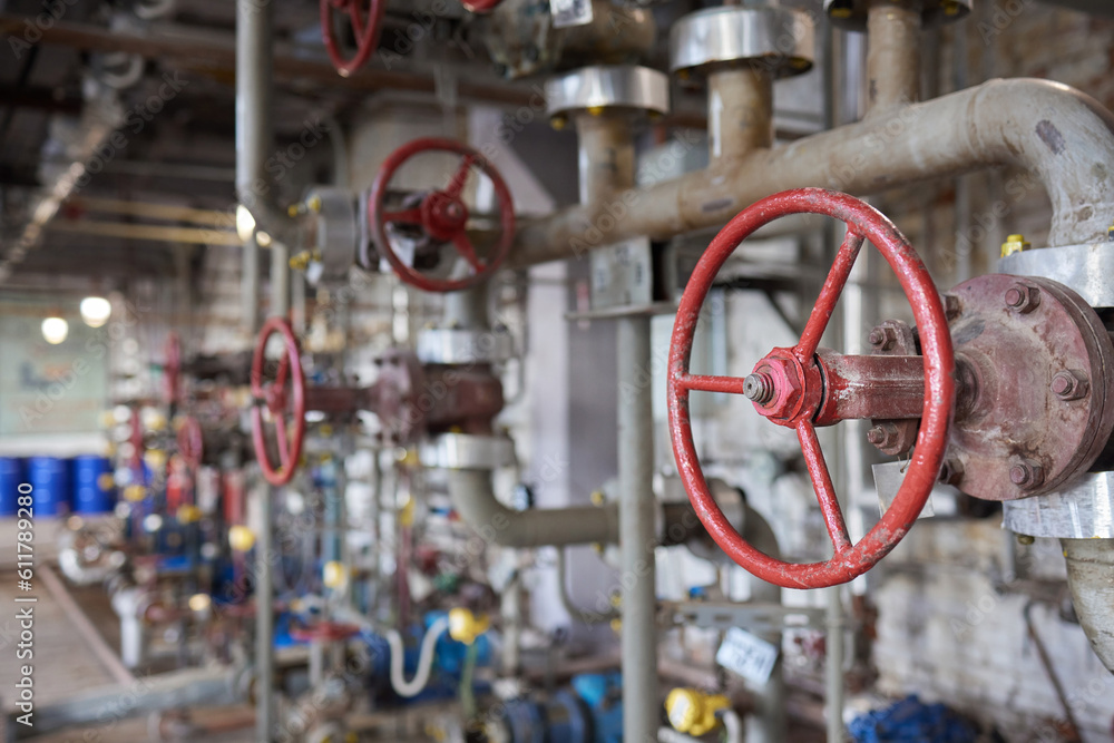 Close-up at pipeline valve which is using to control production process ...