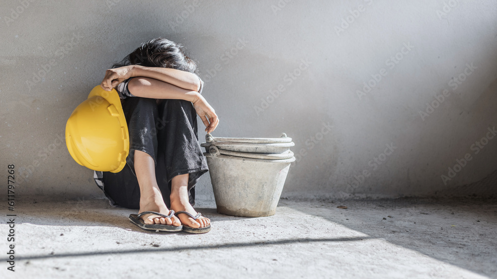 Sad child labor girl relaxing from construction work. World Day Against ...