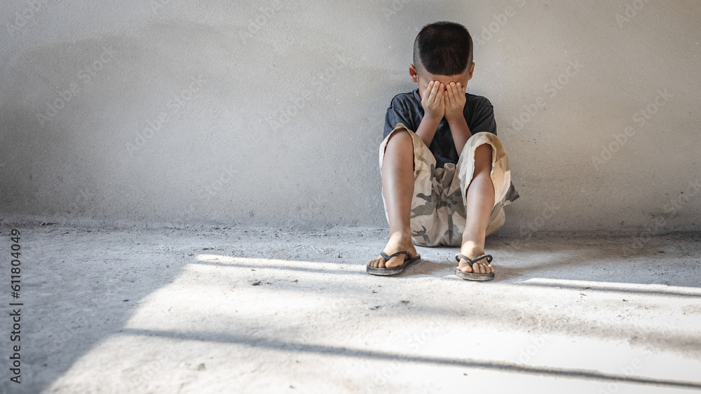 Sad despair young child boy sitting alone on floor concrete wall ...