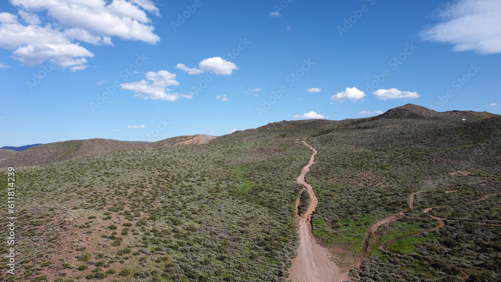 OHV area with rutted paths going up into green mountains Stock Photo ...