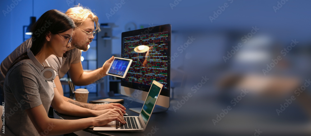 Young programmers working in office at night. Banner for design Stock ...