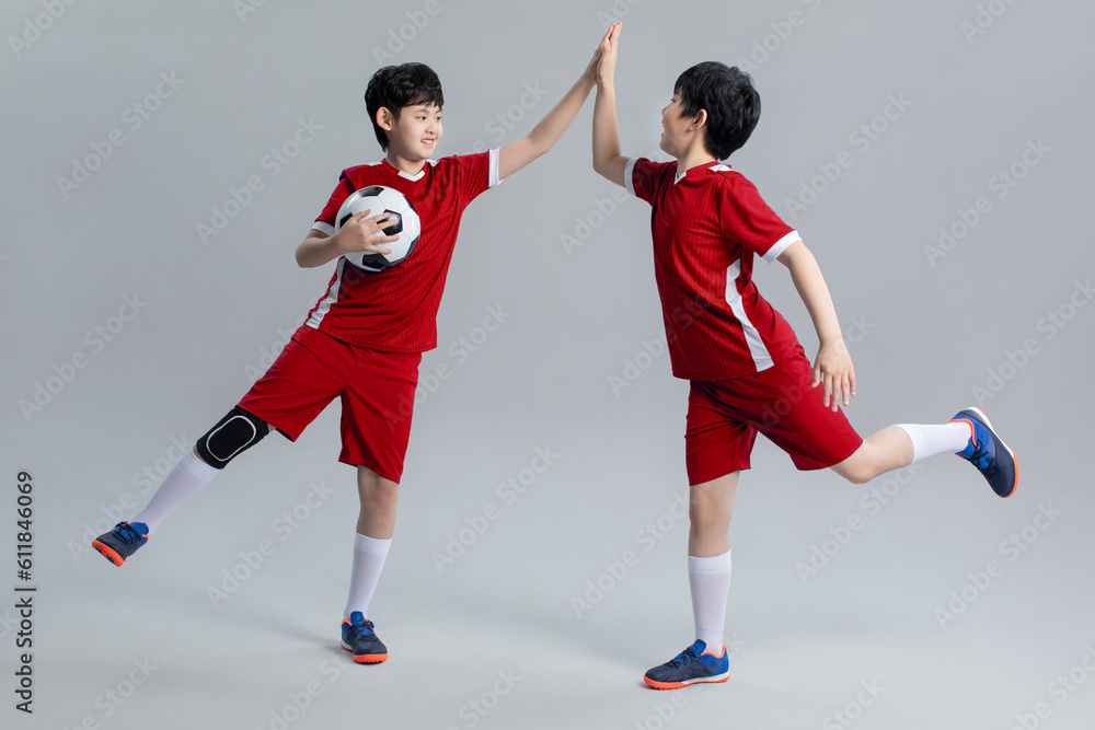 Cute soccer players high fiving Stock Photo | Adobe Stock