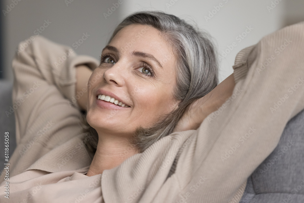 Cheerful beautiful middle aged grey haired woman resting on comfortable ...