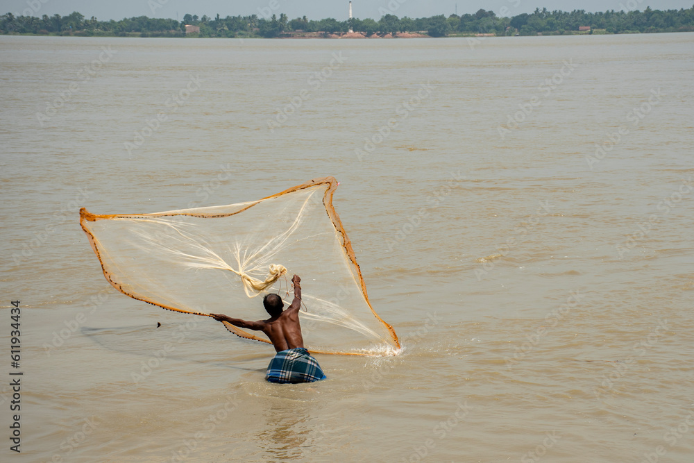 5th June, 2023, Burul, West Bengal, India: A fisherman throwing his ...