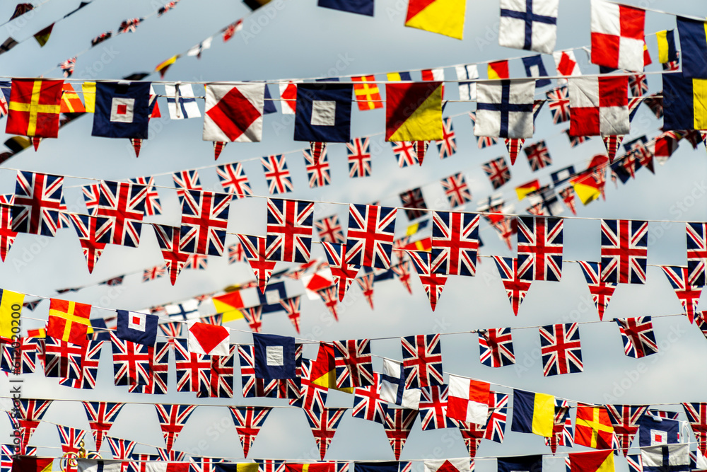 UK Union Jack flags and UK naval signals flags decorate the skyline at ...