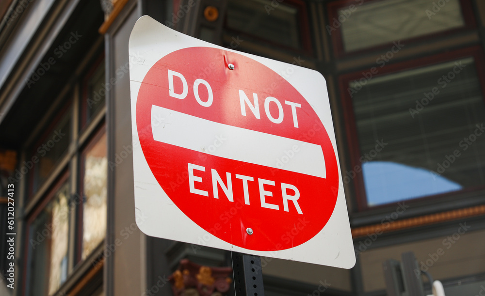 An imposing red 'Do Not Enter' sign stands tall, conveying a powerful ...