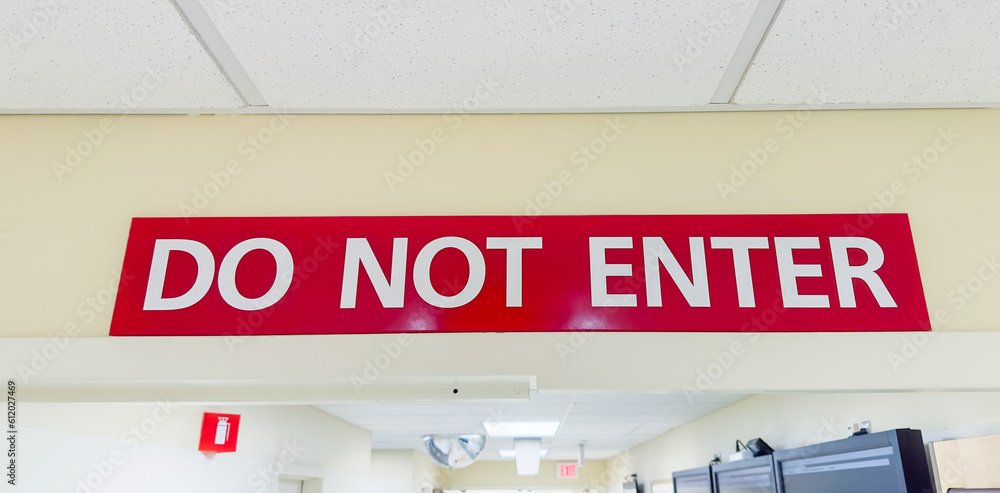 An imposing red 'Do Not Enter' sign stands tall, conveying a powerful ...