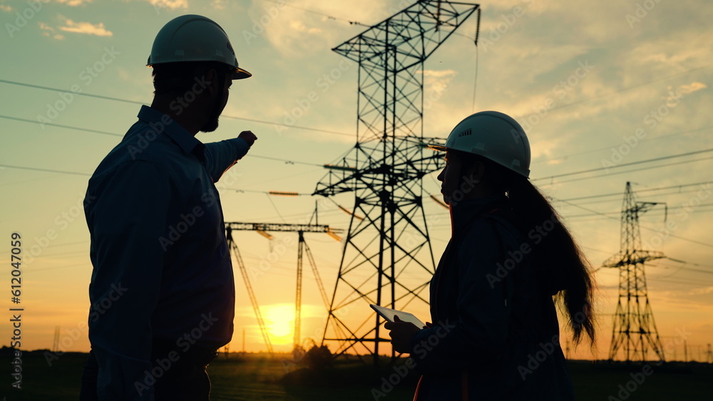 Team of power engineers builders, woman, man, are working together on ...