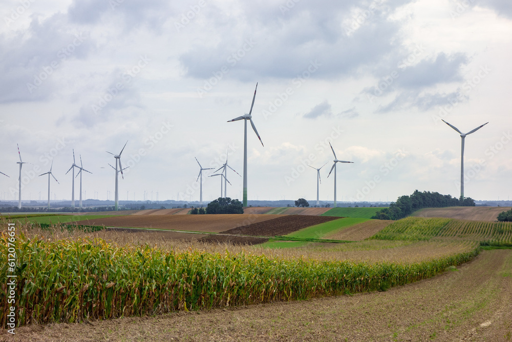 Wind power plant farm with lot of turbines in the agricultural ...