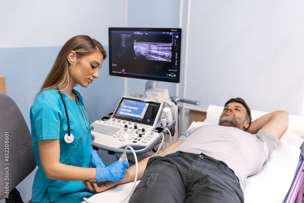 Doctor check ultrasound of patient arm in a clinic for medical and ...