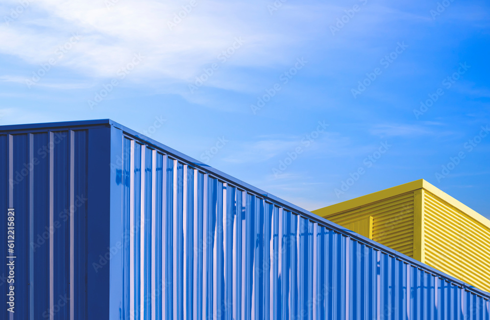 Colorful blue and yellow corrugated metal warehouse industrial ...