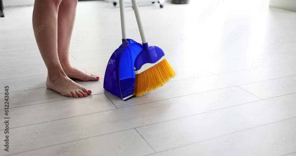 Household routine and closeup of woman with bare feet sweeping floor of ...