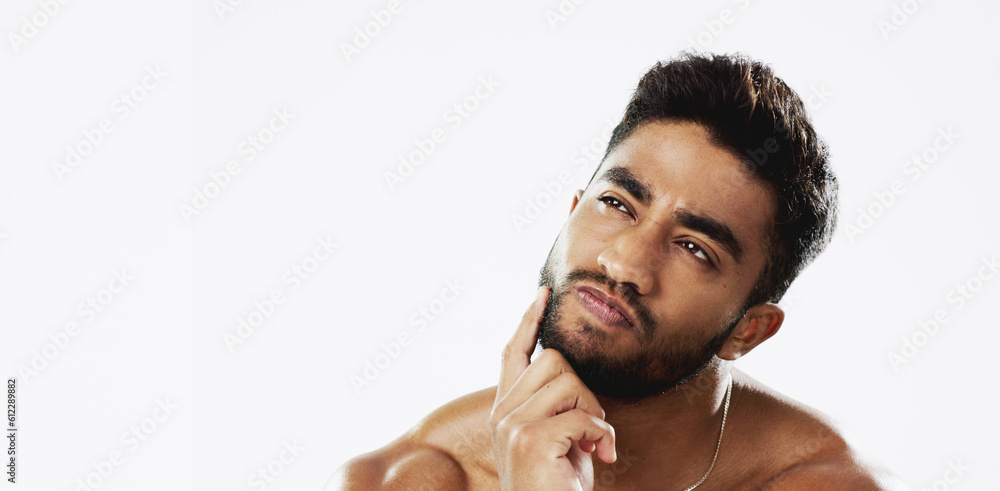 Confused, thinking and face of man in studio for wellness, skincare and ...